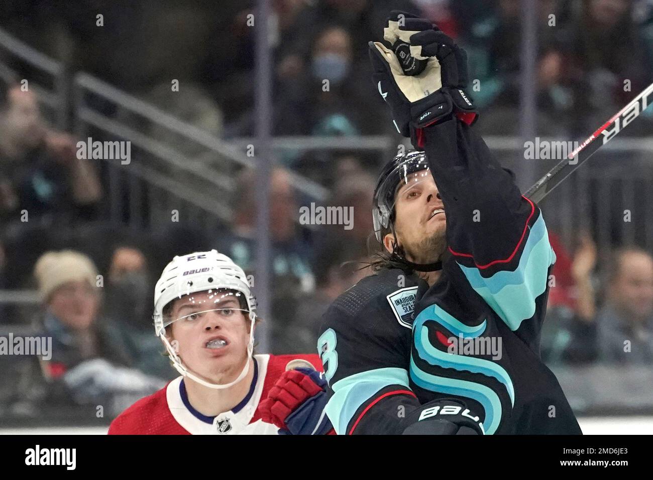 Seattle Kraken left wing Brandon Tanev (13) reaches for the puck as ...