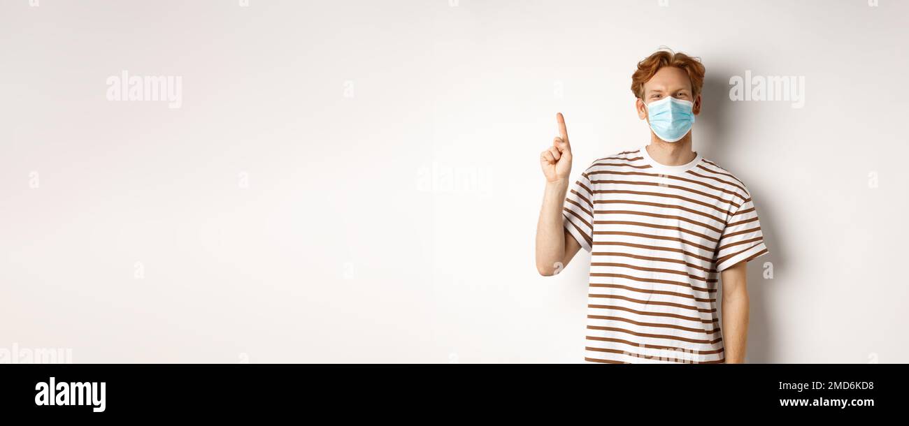 Covid, virus and social distancing concept. Young male student with red ...