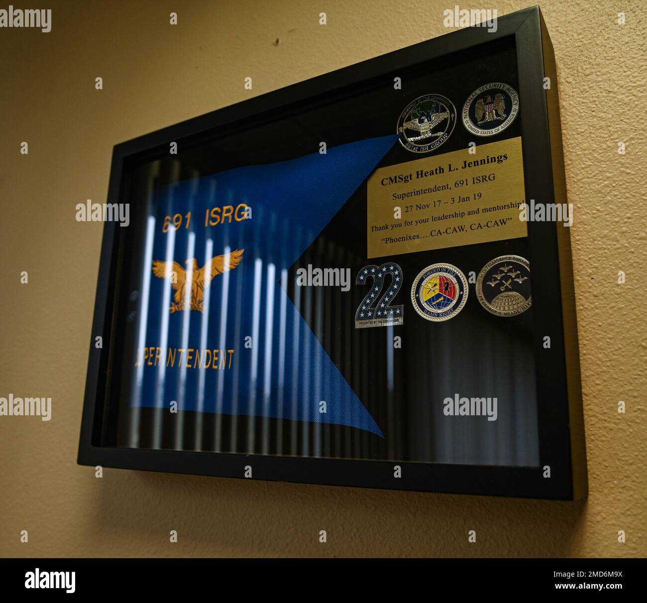 A shadow box containing the coins and guidon of the unit Chief Master ...