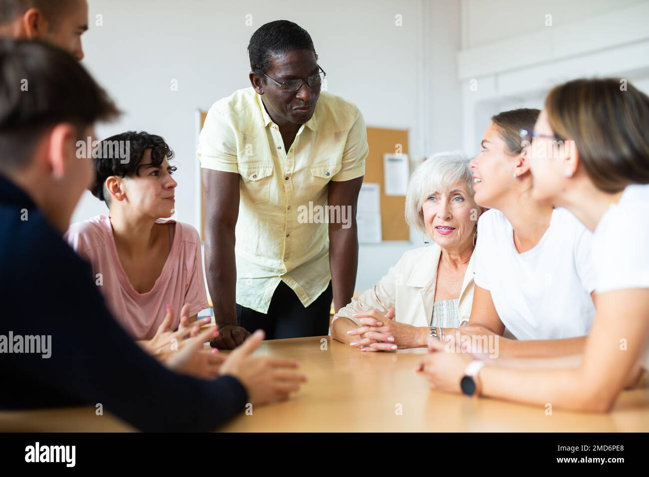 Multiracial mixed age group participating adult education class with ...