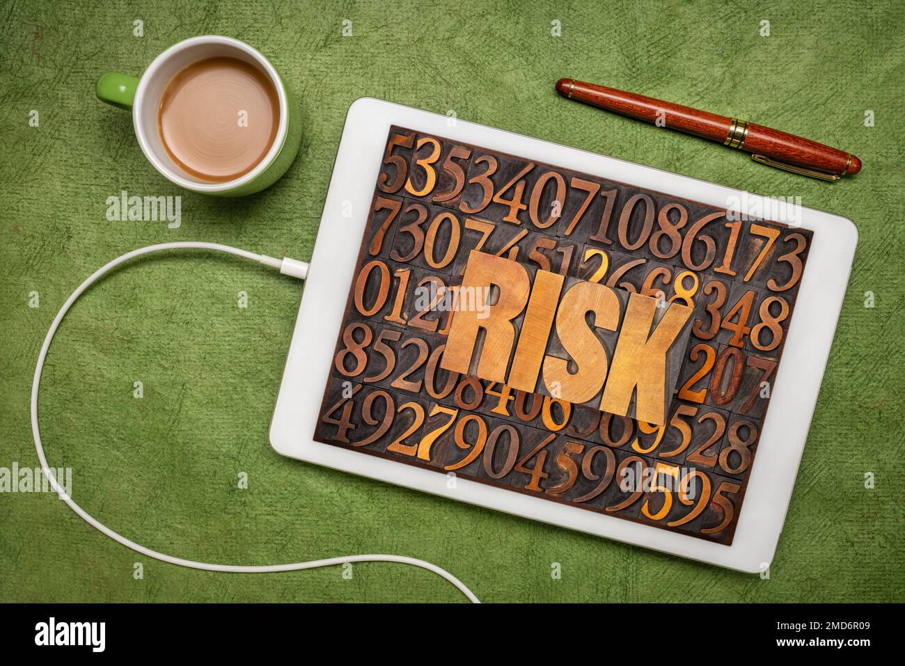 risk word - letterpress wood type text against numbers on a digital ...