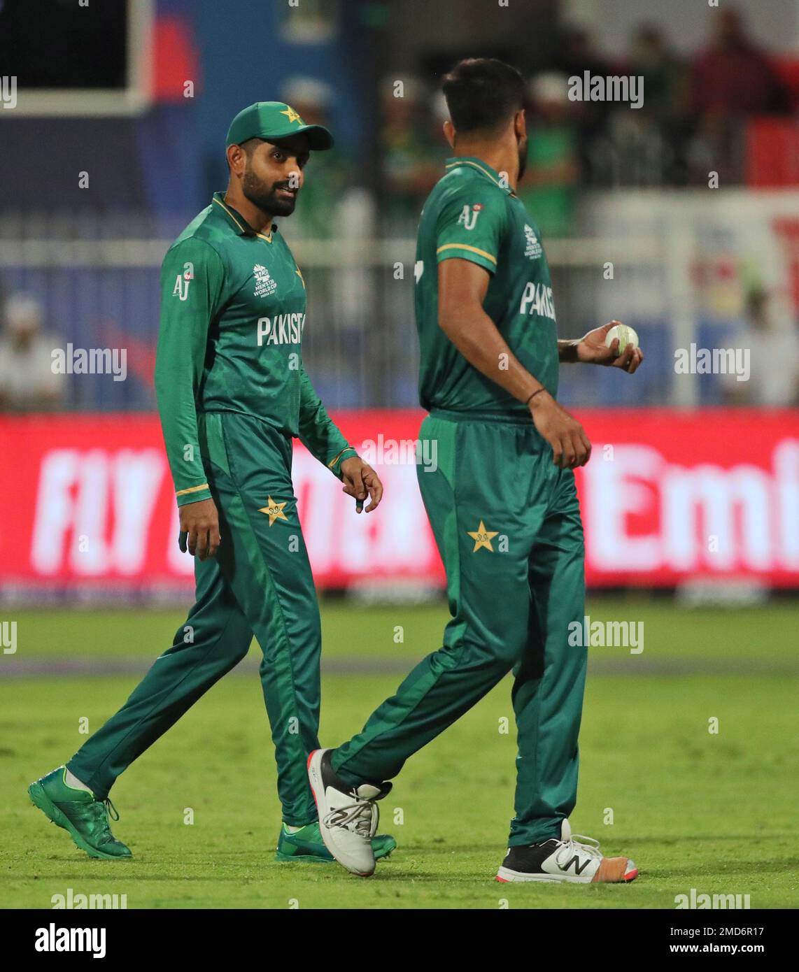 Pakistan's captain Babar Azam talks to Haris Rauf before Rauf bowls his ...