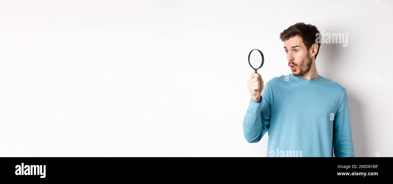 Man got surprised while looking through magnifying glass, saying wow at ...