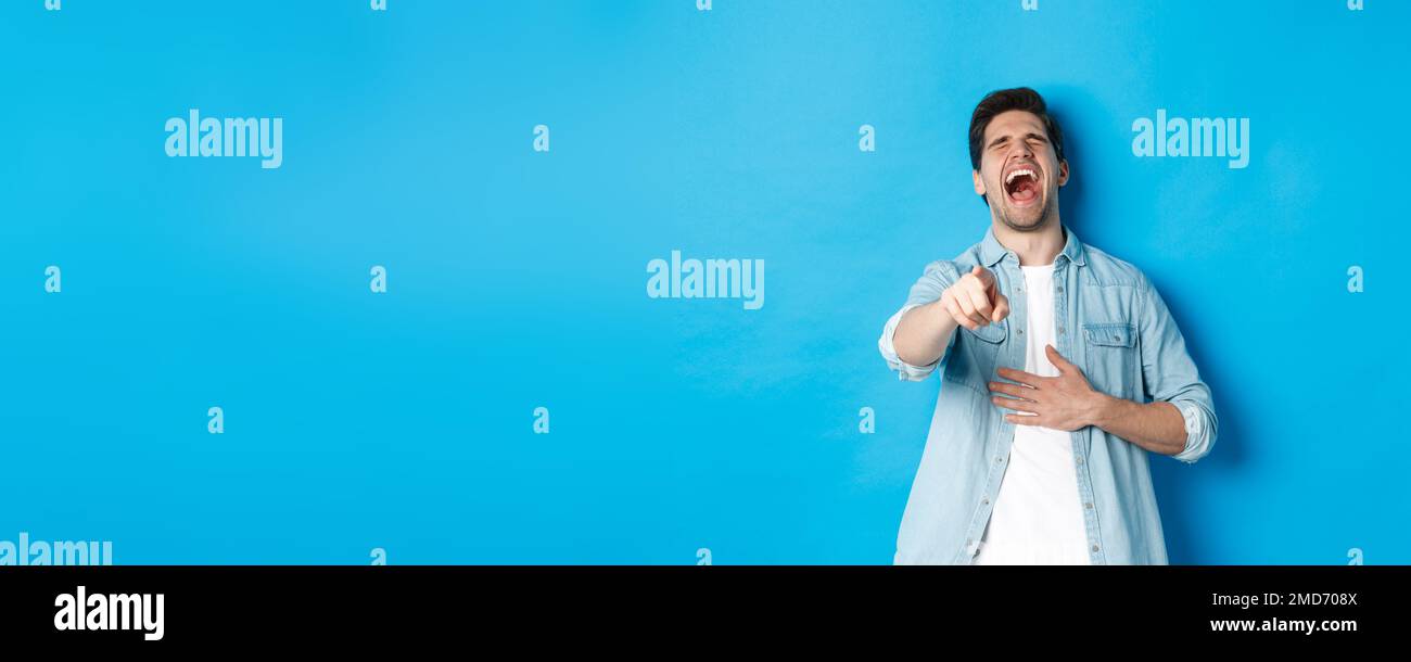Adult man in casual outfit laughing out loud and pointing at you ...