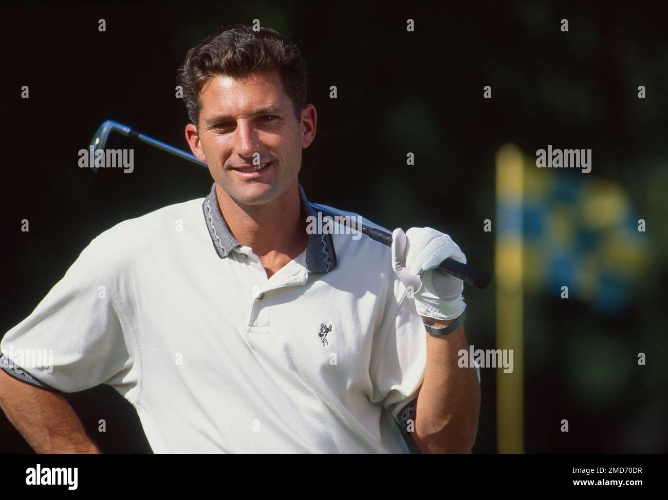 Man posing for a portrait. While golfing with club in his hand over his ...