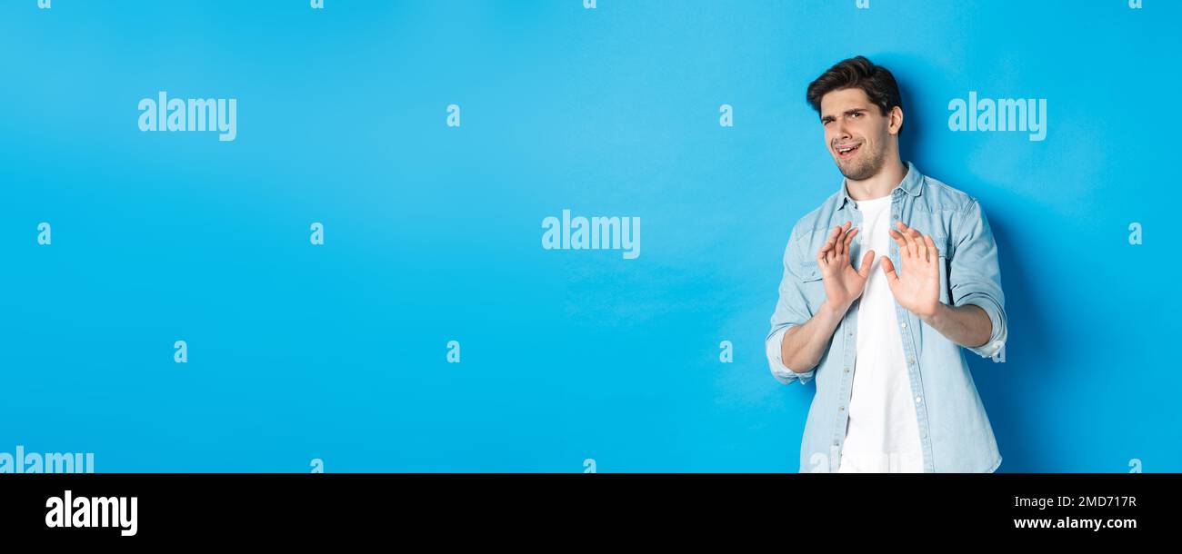 Displeased man refusing, saying no and cringe from something disgusting ...