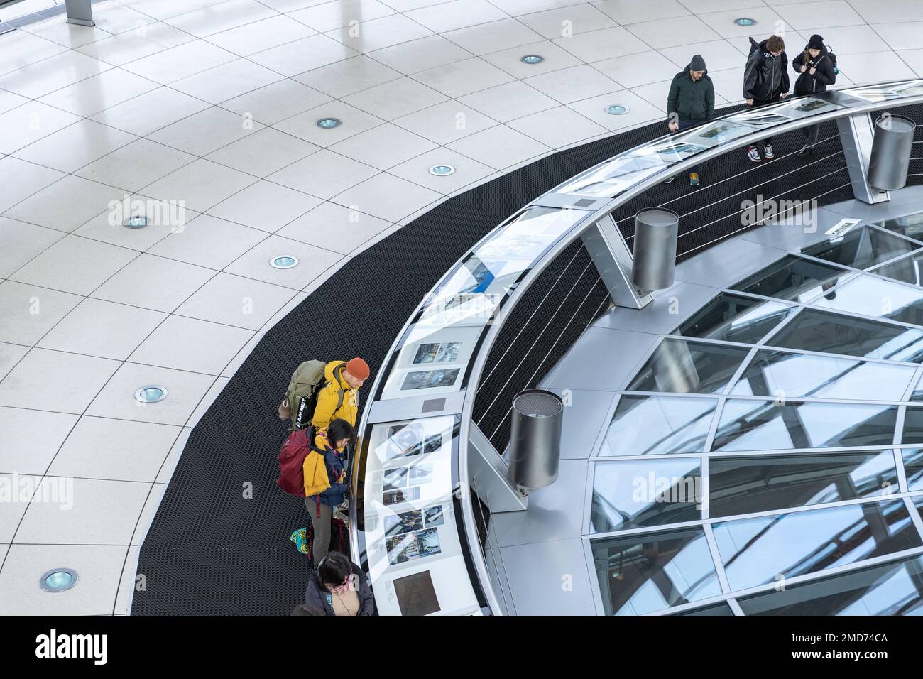 Inside the Bundestag dome. Tourists visit the parliament building of ...