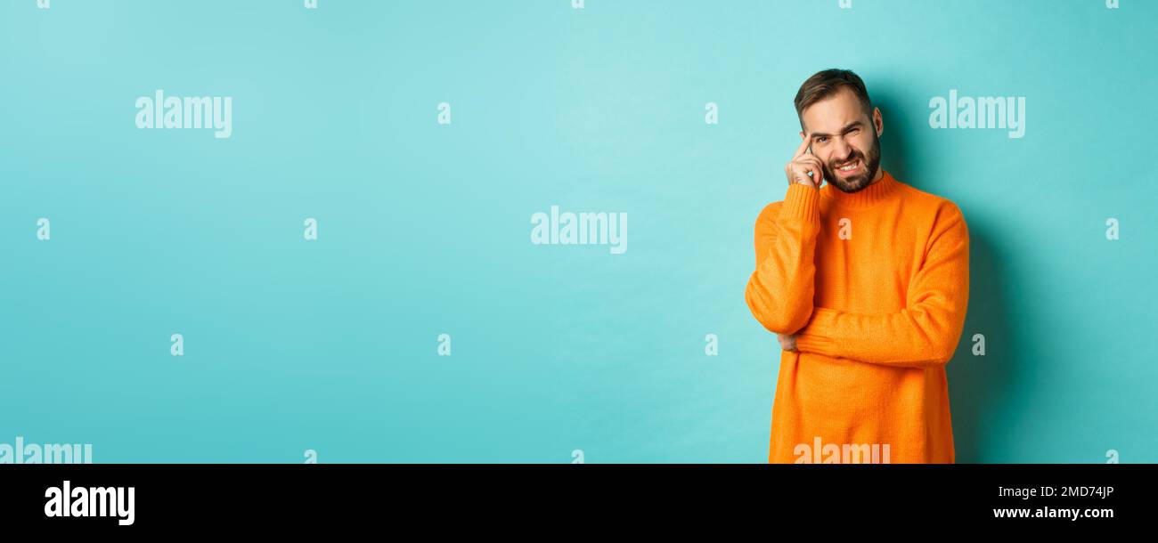 Man with beard, grimacing and cringe from something embarrassing ...