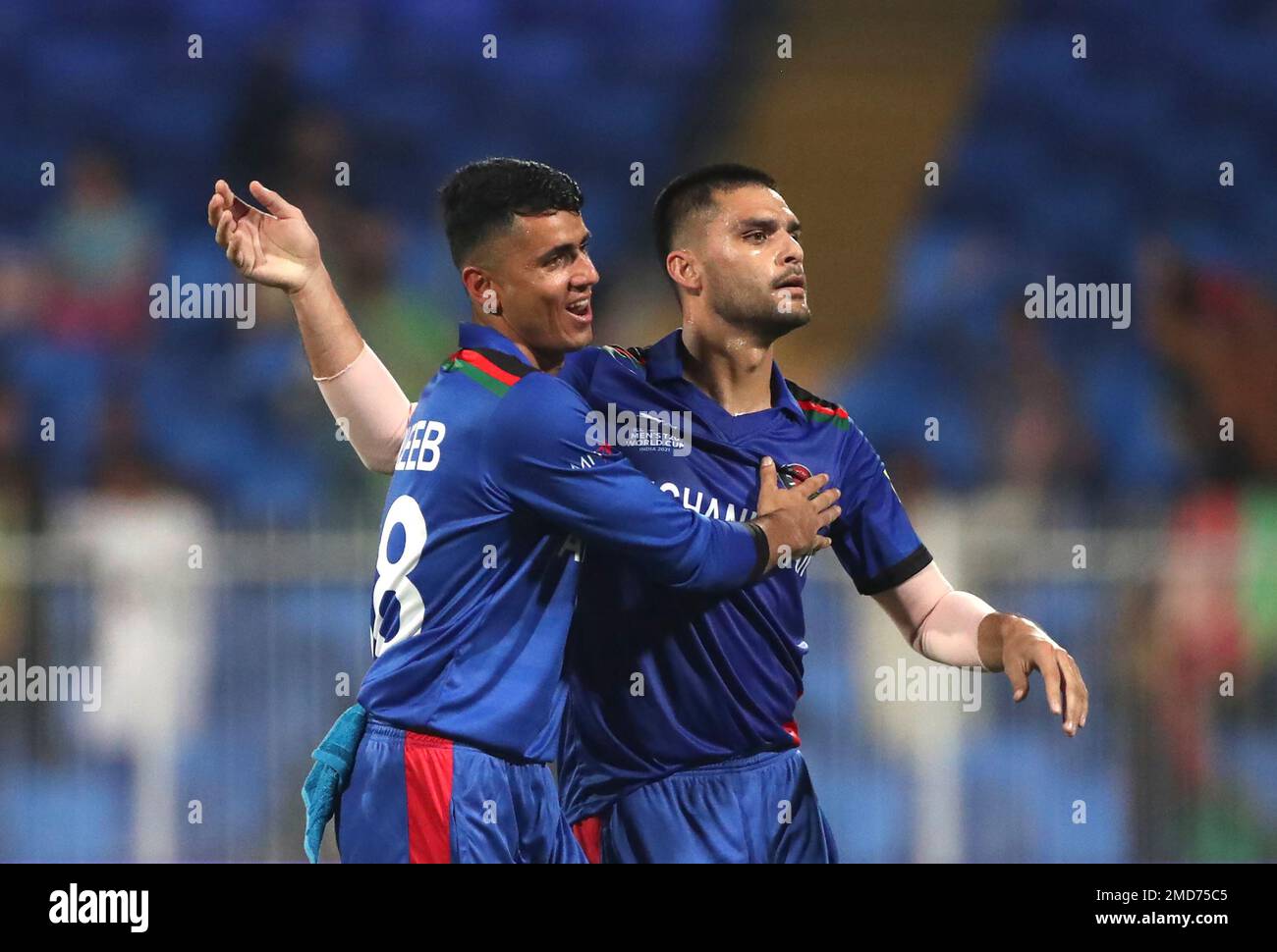 Afghanistan's Naveen-ul-Haq, right, celebrates the dismissal of ...