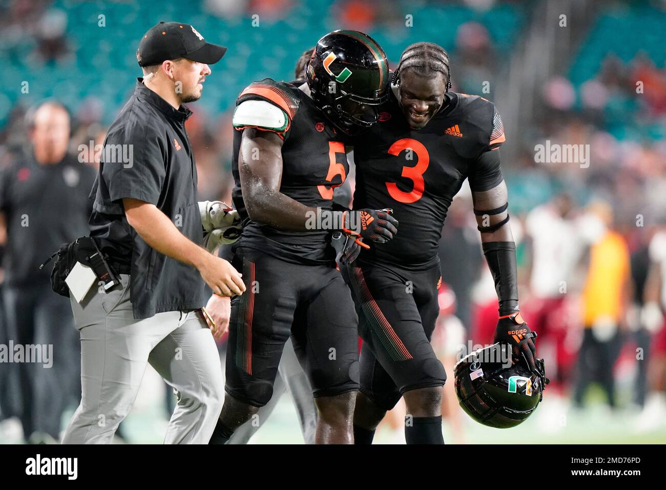 Miami safety Amari Carter (5) is helped off the field after a play ...