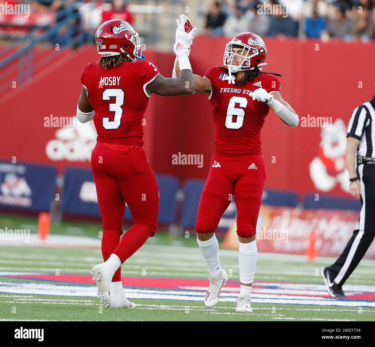 Fresno State linebacker Levelle Bailey, right, high fives defensive end ...