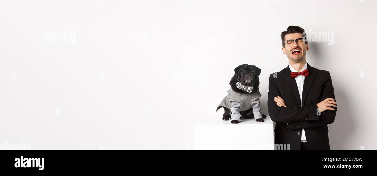 Animals, party and celebration concept. Sad dog owner crying, wearing ...