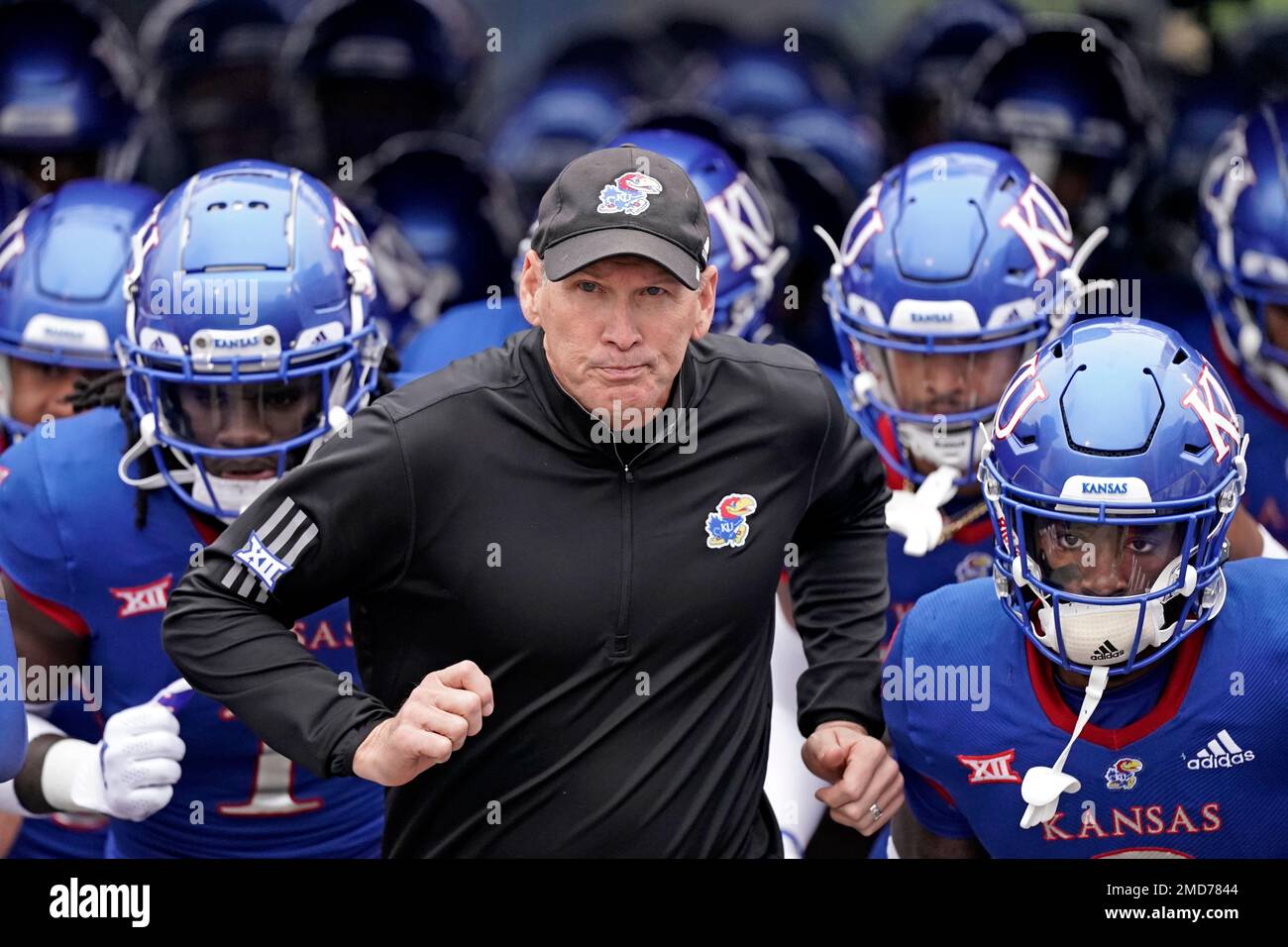 Kansas head coach Lance Leipold leads his team onto the field before an ...
