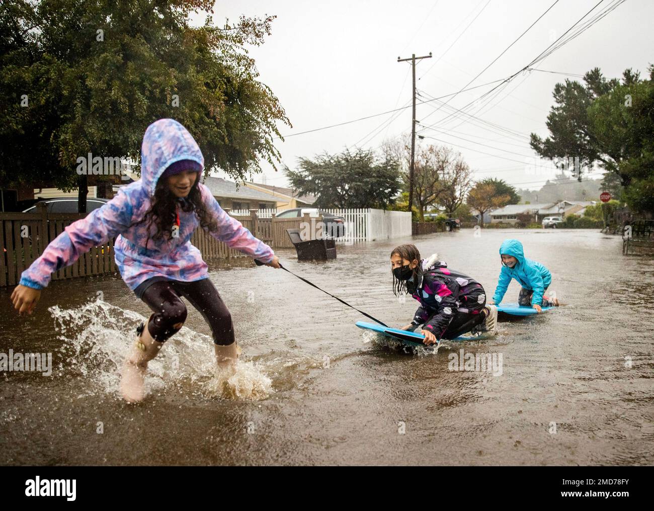 Children play in floodwaters on Robin Road in Mill Valley, Calif., on ...