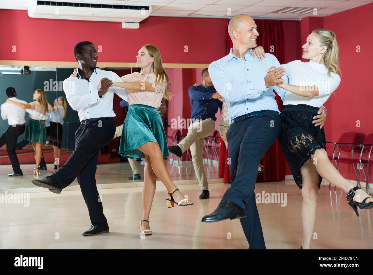 Young positive people dancing vigorous jive movements in dance studio Stock Photo - Alamy