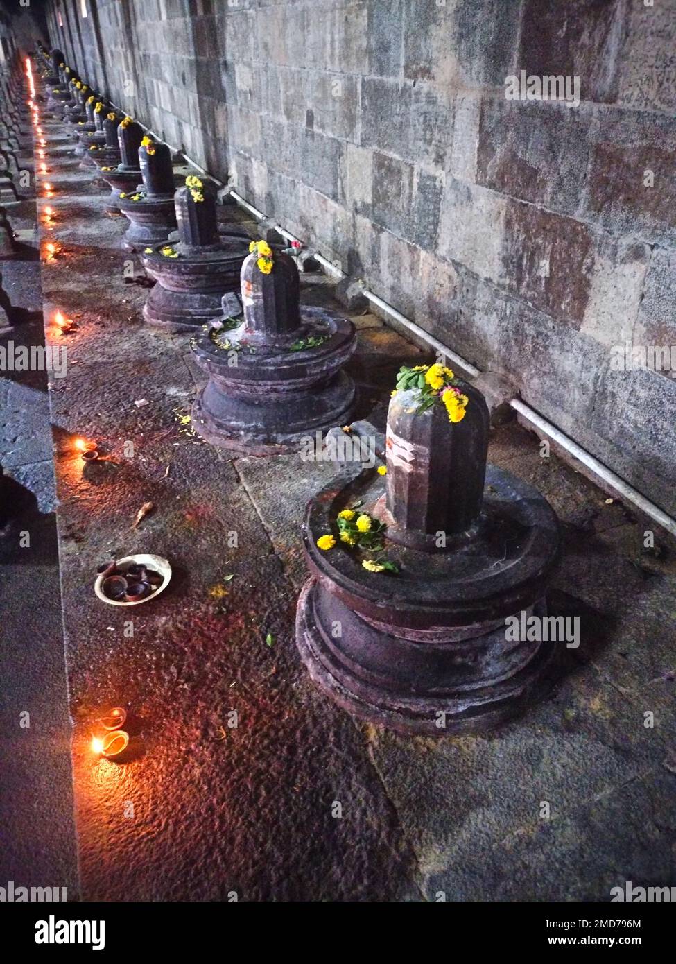 A vertical shot of Lingam, the symbol of the divine producing power in ...