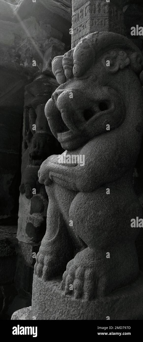 A grayscale vertical shot of Lion sculpture pillar in Kailasanathar ...