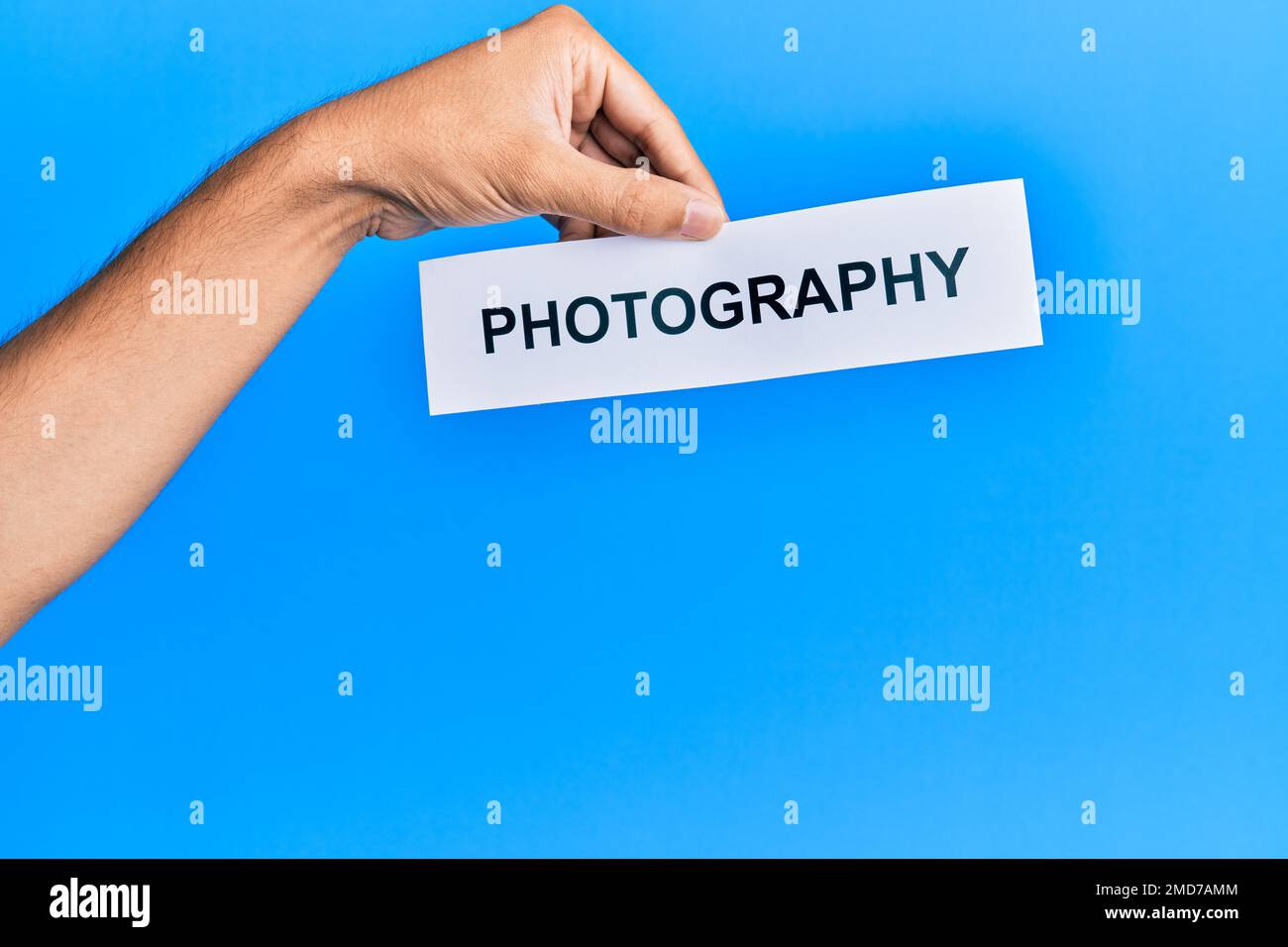 Hand of caucasian man holding paper with photography word over isolated ...