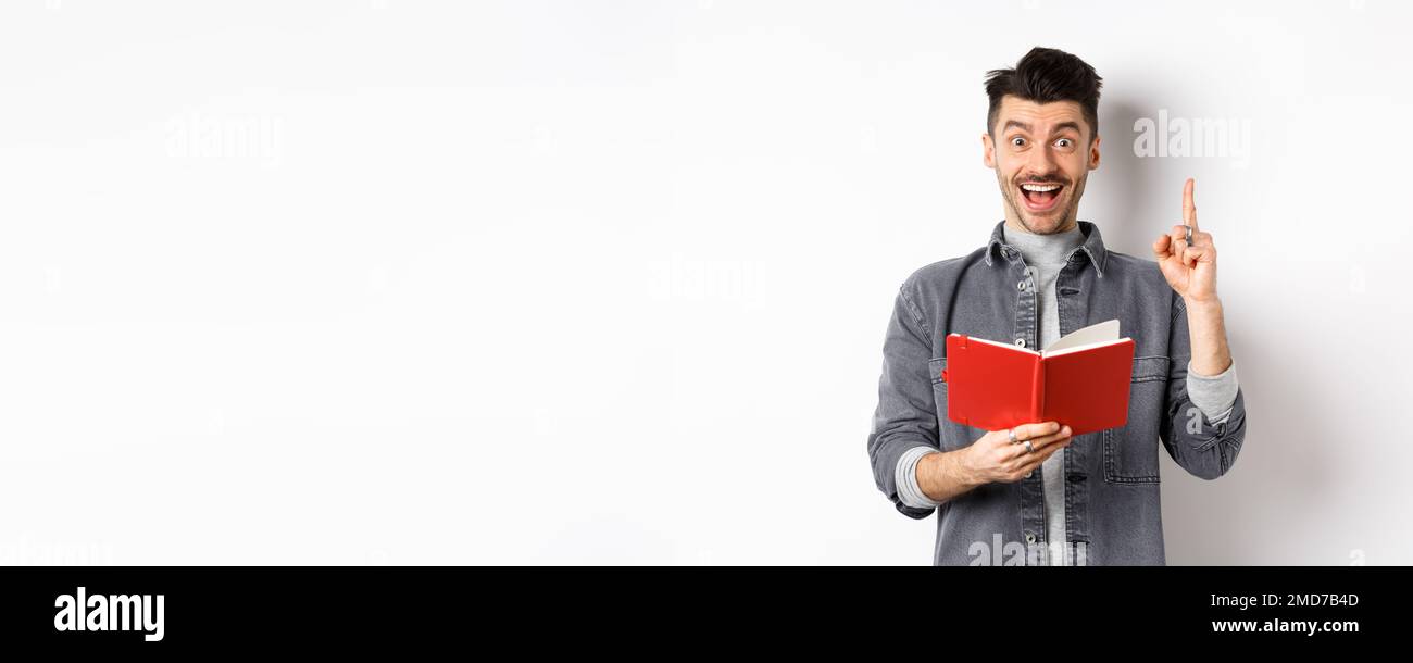 Excited guy pitching an idea while doing homework, raising finger and ...