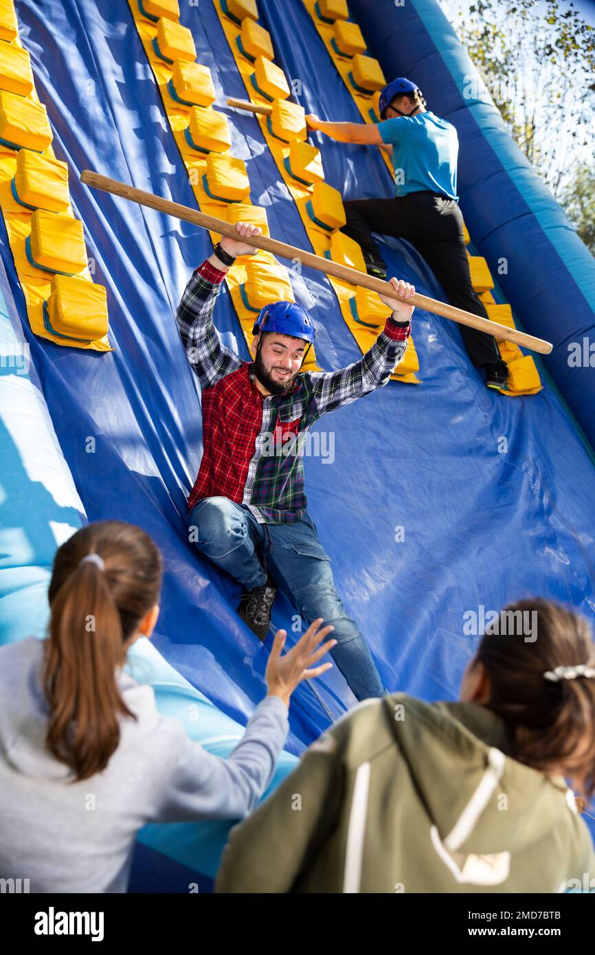 Friends having fun passing obstacle course Stock Photo - Alamy