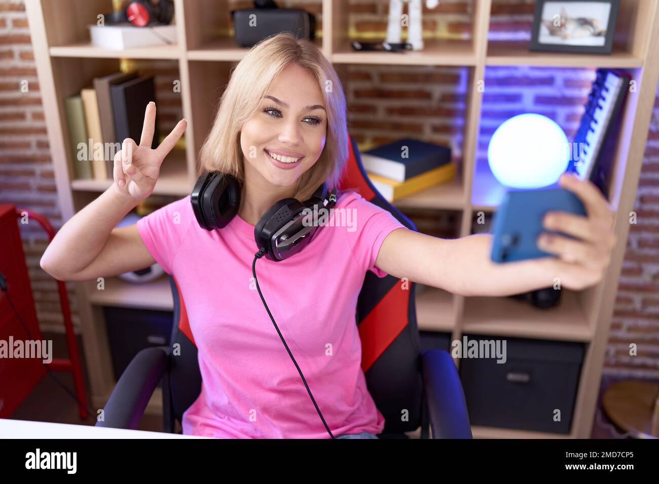 Young blonde woman streamer smiling confident make selfie by smartphone ...