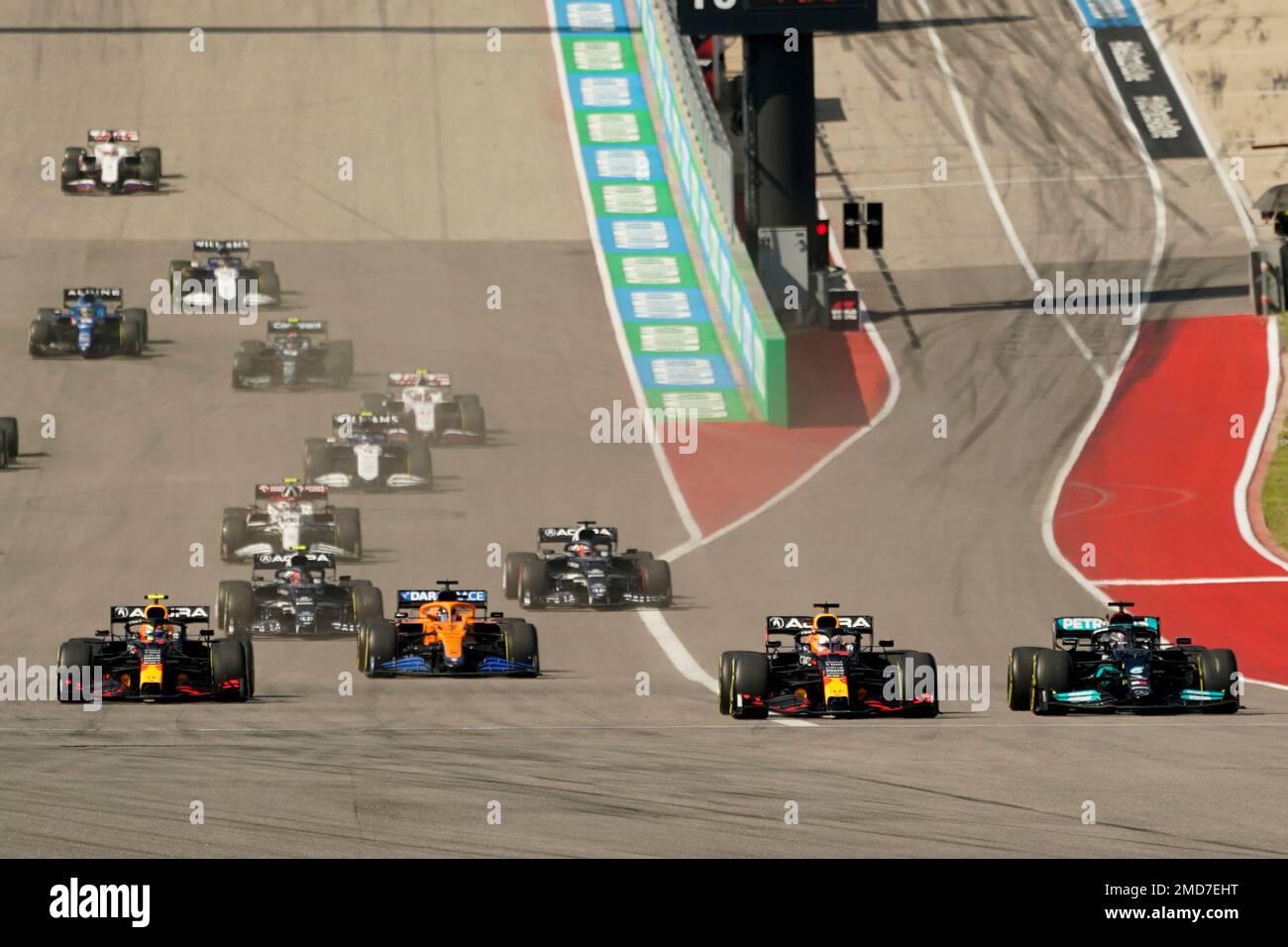 Red Bull driver Max Verstappen, of the Netherlands, squeezes Mercedes driver Lewis Hamilton, of ...