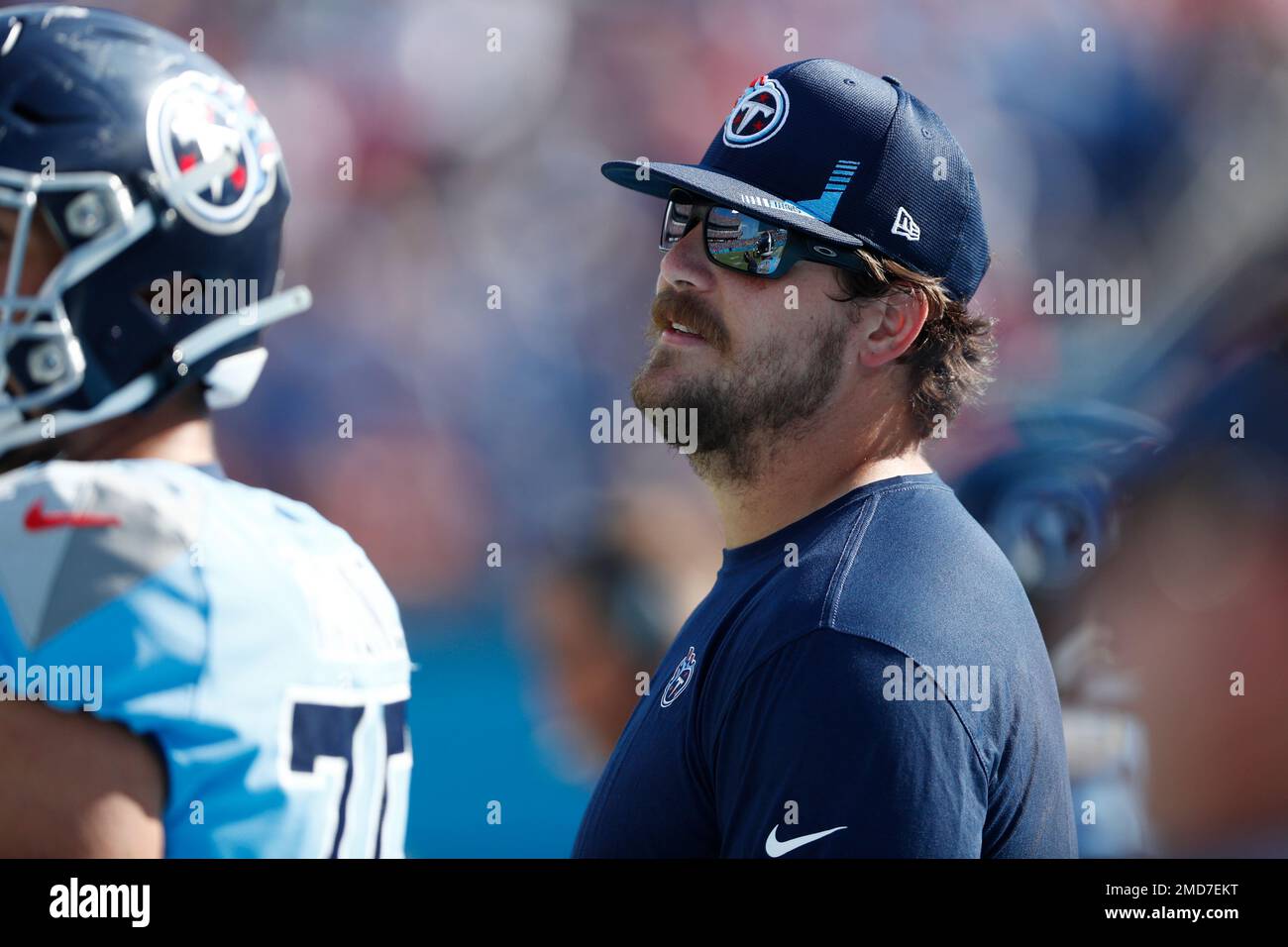 Tennessee Titans injured offensive tackle Taylor Lewan watches from the ...