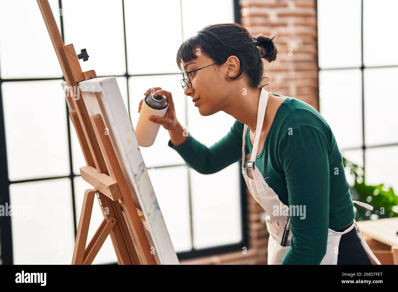 Young beautiful hispanic woman artist smiling confident using graffiti ...