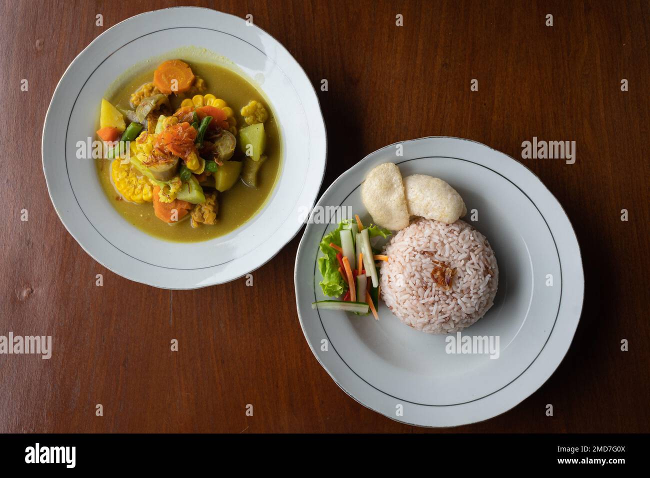 Top down view of a Sayur Kare (Balinese Vegetable Curry) on white plate ...