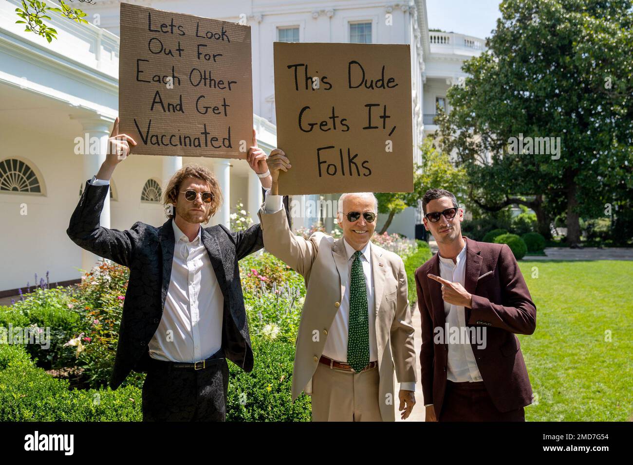 Reportage: President Joe Biden holds up signs with social media ...