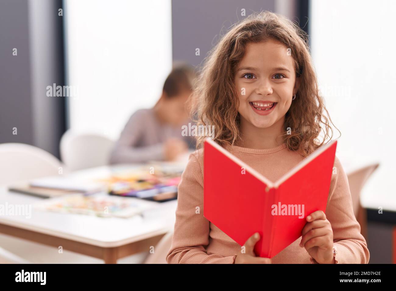 Two kids students reading book studying at classroom Stock Photo - Alamy