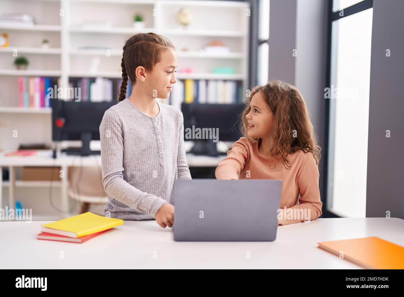Two kids students using computer studying at classroom Stock Photo - Alamy