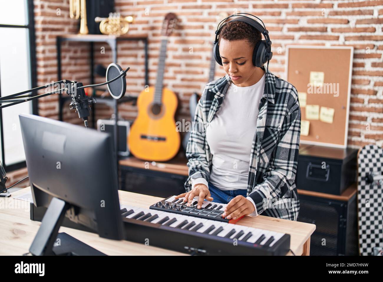 African american woman musician having dj session at music studio Stock ...