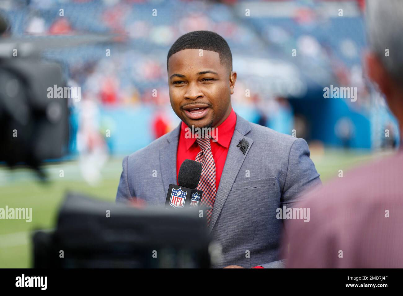 NFL reporter Cameron Wolfe works before an NFL football game between ...