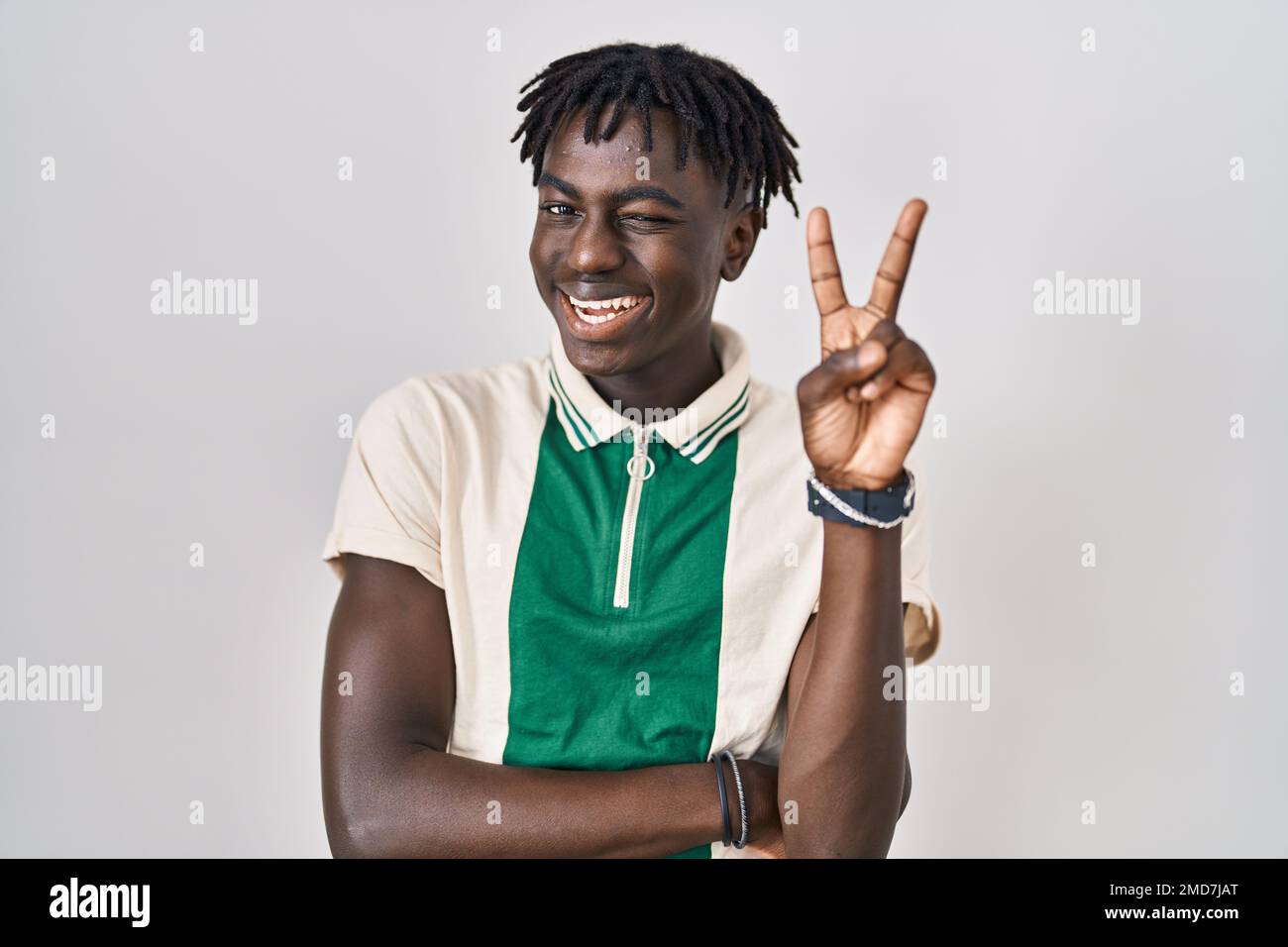 African man with dreadlocks standing over isolated background smiling ...