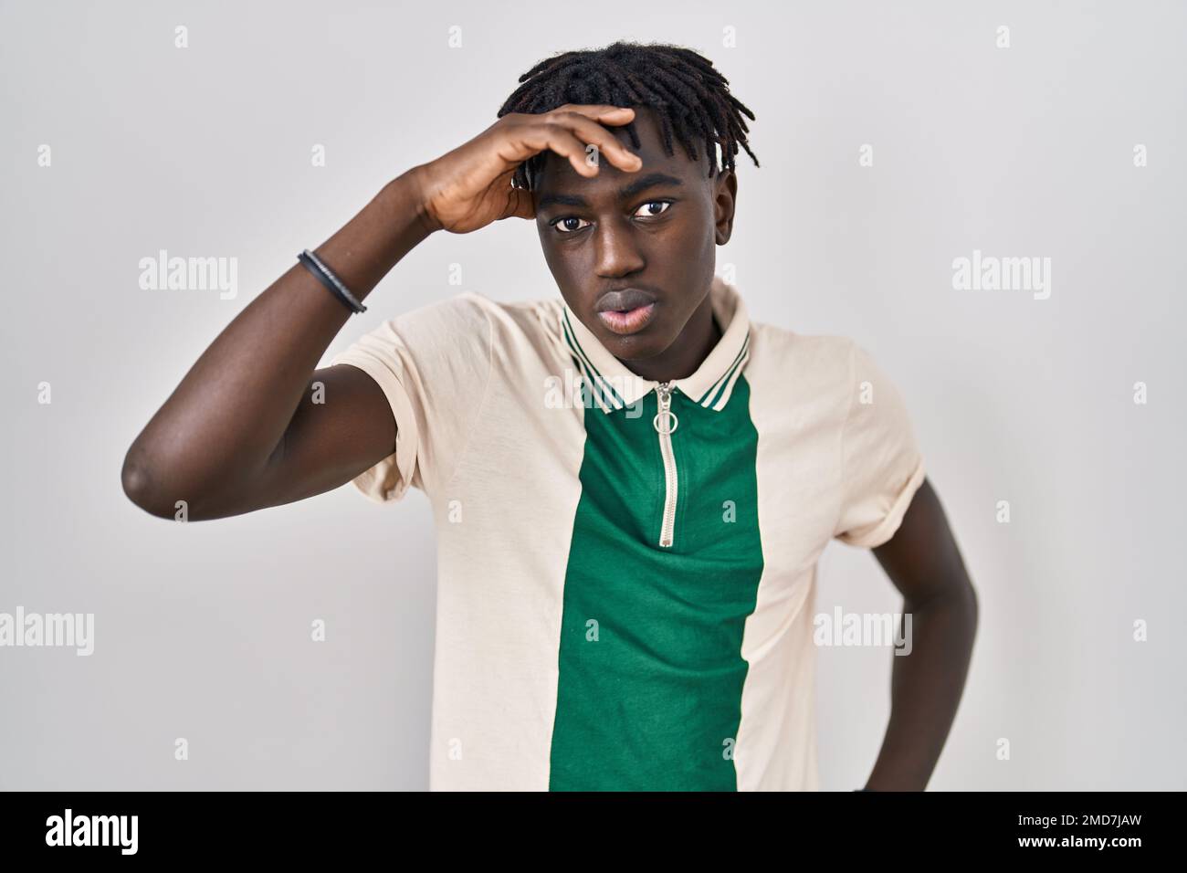 African man with dreadlocks standing over isolated background worried ...