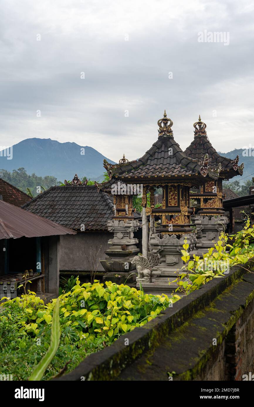 View of traditional Balinese temple with mountains in the background ...