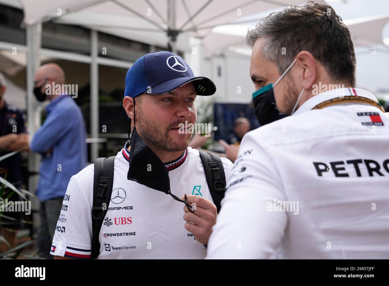 Mercedes driver Valtteri Bottas, of Finland, talks with a crew member ...