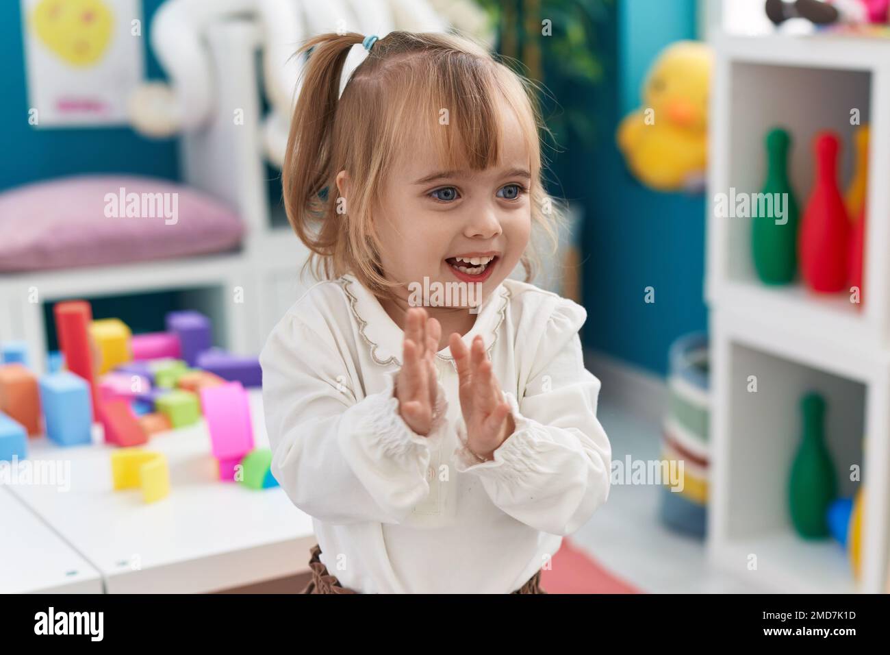 Adorable blonde girl smiling confident clapping hands at kindergarten Stock Photo - Alamy