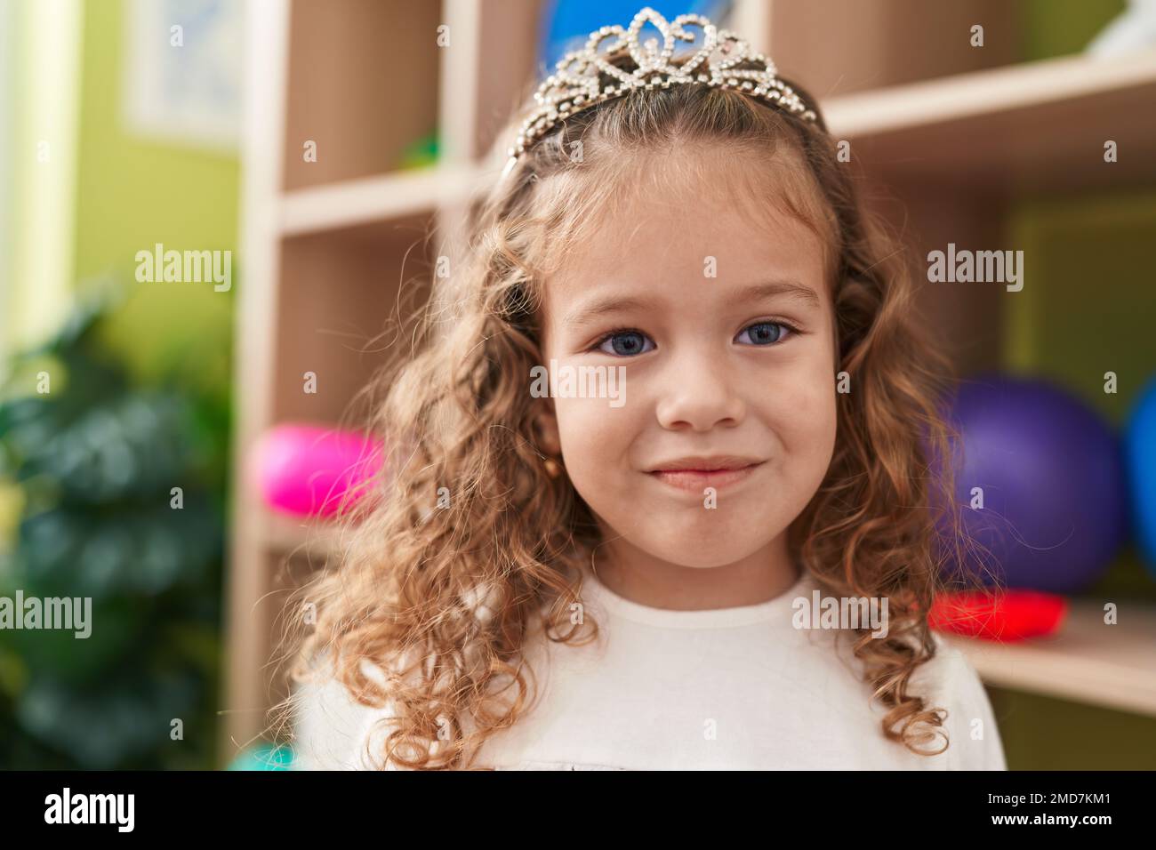 Adorable blonde toddler smiling confident wearing princess crown at kindergarten Stock Photo - Alamy