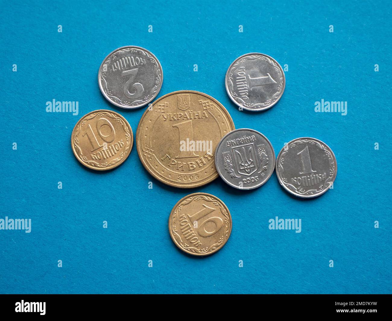 Several steel and bronze Ukrainian coins, hryvnias on blue background ...