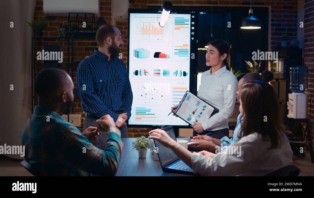 Diverse coworkers presenting company annual statistics report, employee ...