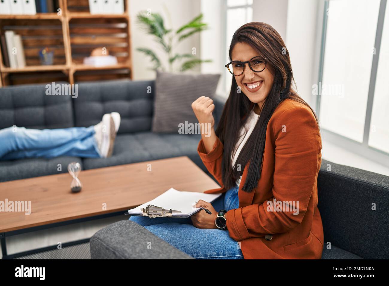 Young hispanic woman working as psychology counselor very happy and ...