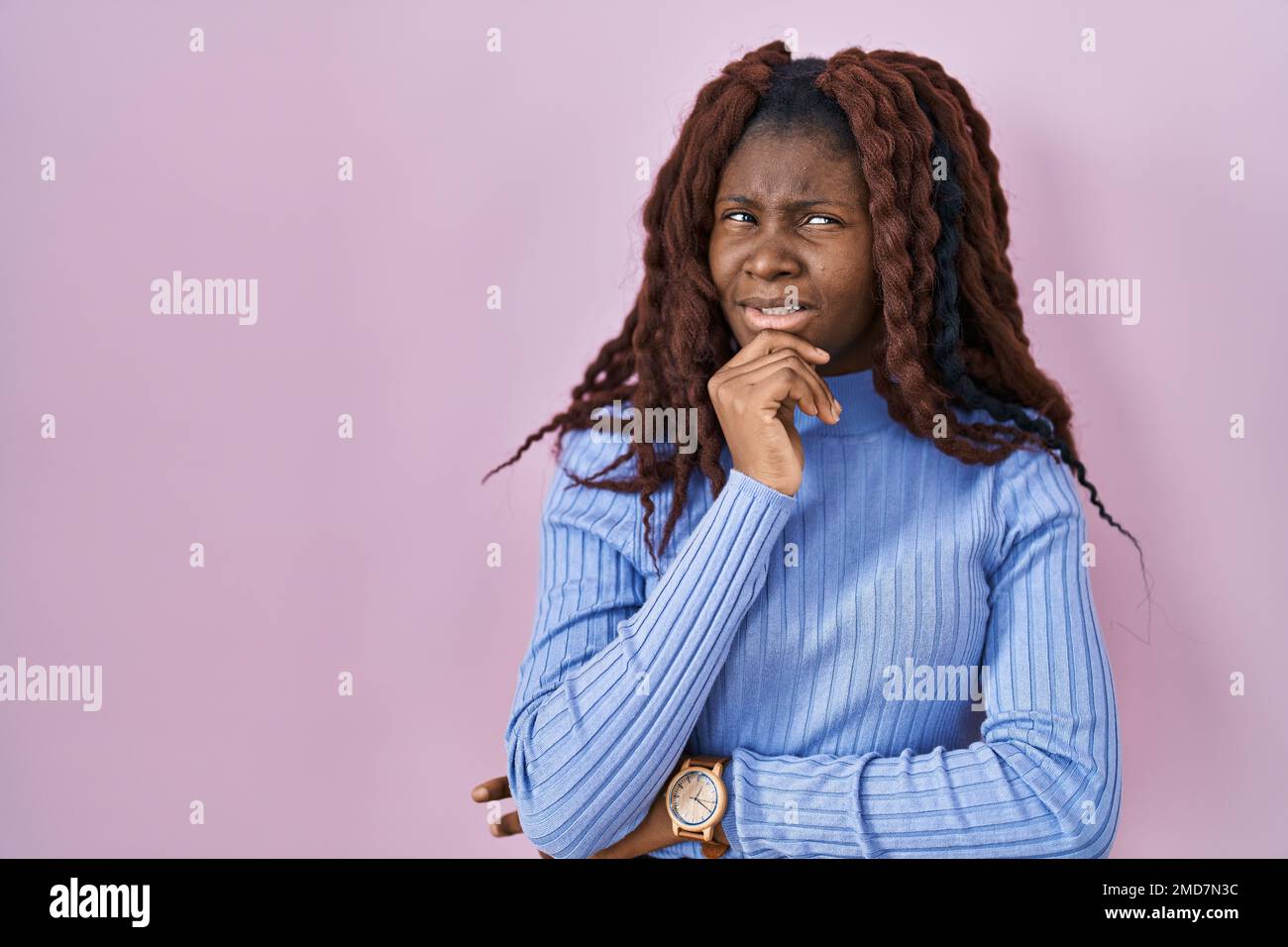 African woman standing over pink background thinking worried about a ...