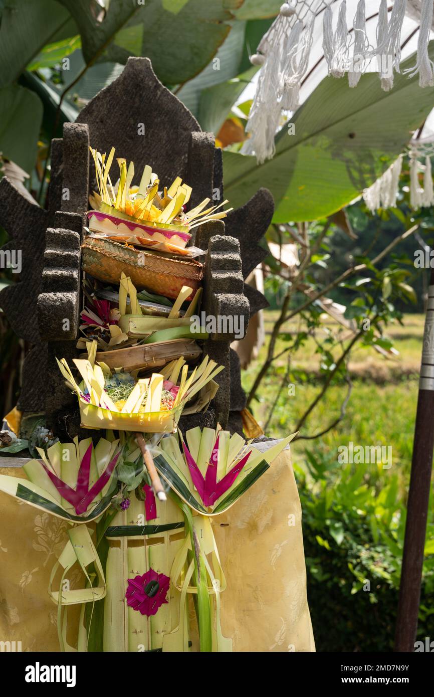 A traditional altar in Bali, Indonesia, decorated with yellow fabric ...