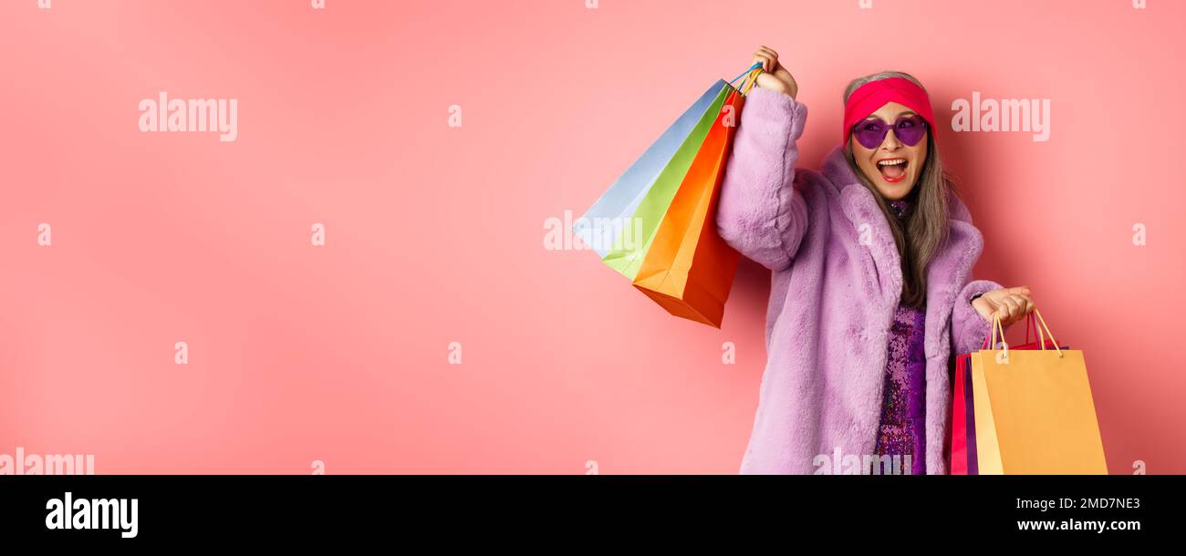 Stylish asian senior woman going shopping, wearing trendy clothes and ...