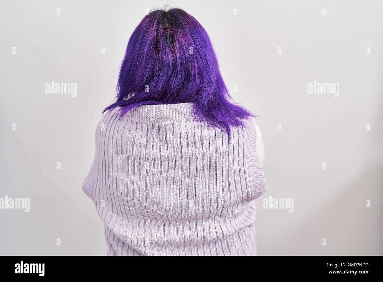 Plus size woman wit purple hair standing over white background standing ...