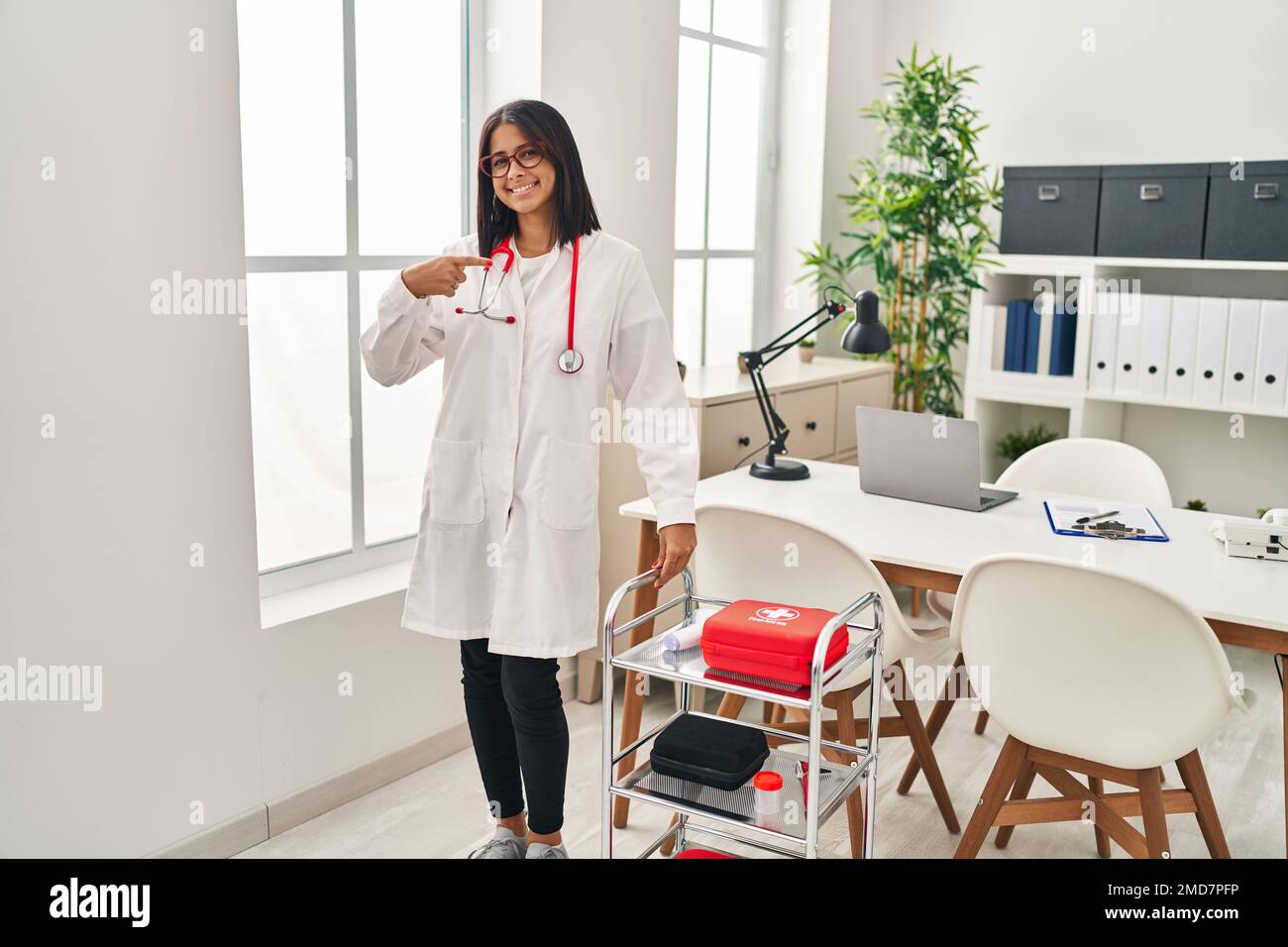 Young hispanic woman wearing doctor uniform and stethoscope smiling ...