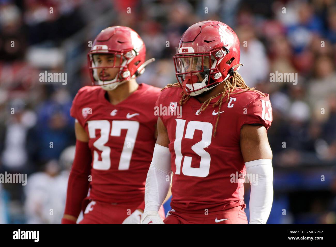 Washington State linebackers Jahad Woods (13) and Justus Rogers (37 ...