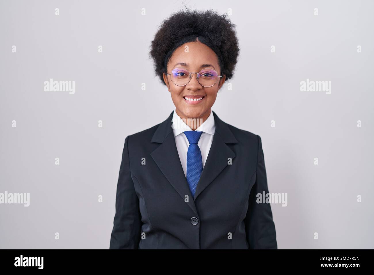 Beautiful african woman with curly hair wearing business jacket and ...